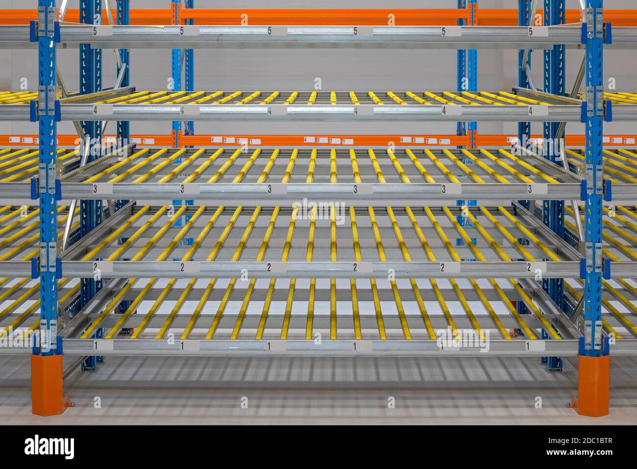 Gravity Flow Rack Shelving in Distribution Warehouse Stock Photo - Alamy