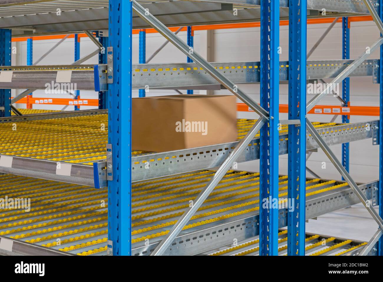 Gravity Flow Rack Shelving in Distribution Warehouse Stock Photo - Alamy