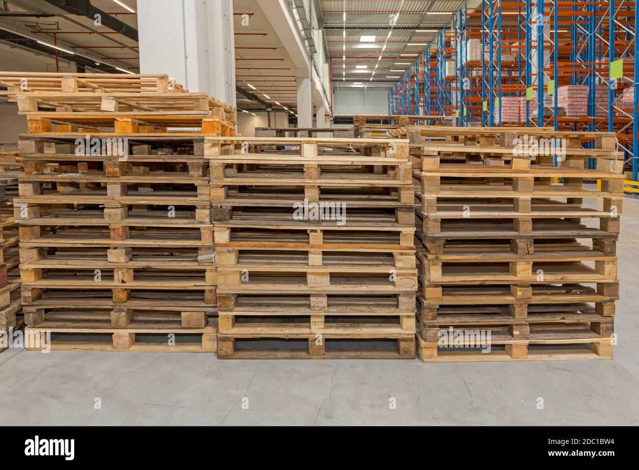 Wooden Pallets Stacked in Distribution Warehouse Stock Photo - Alamy