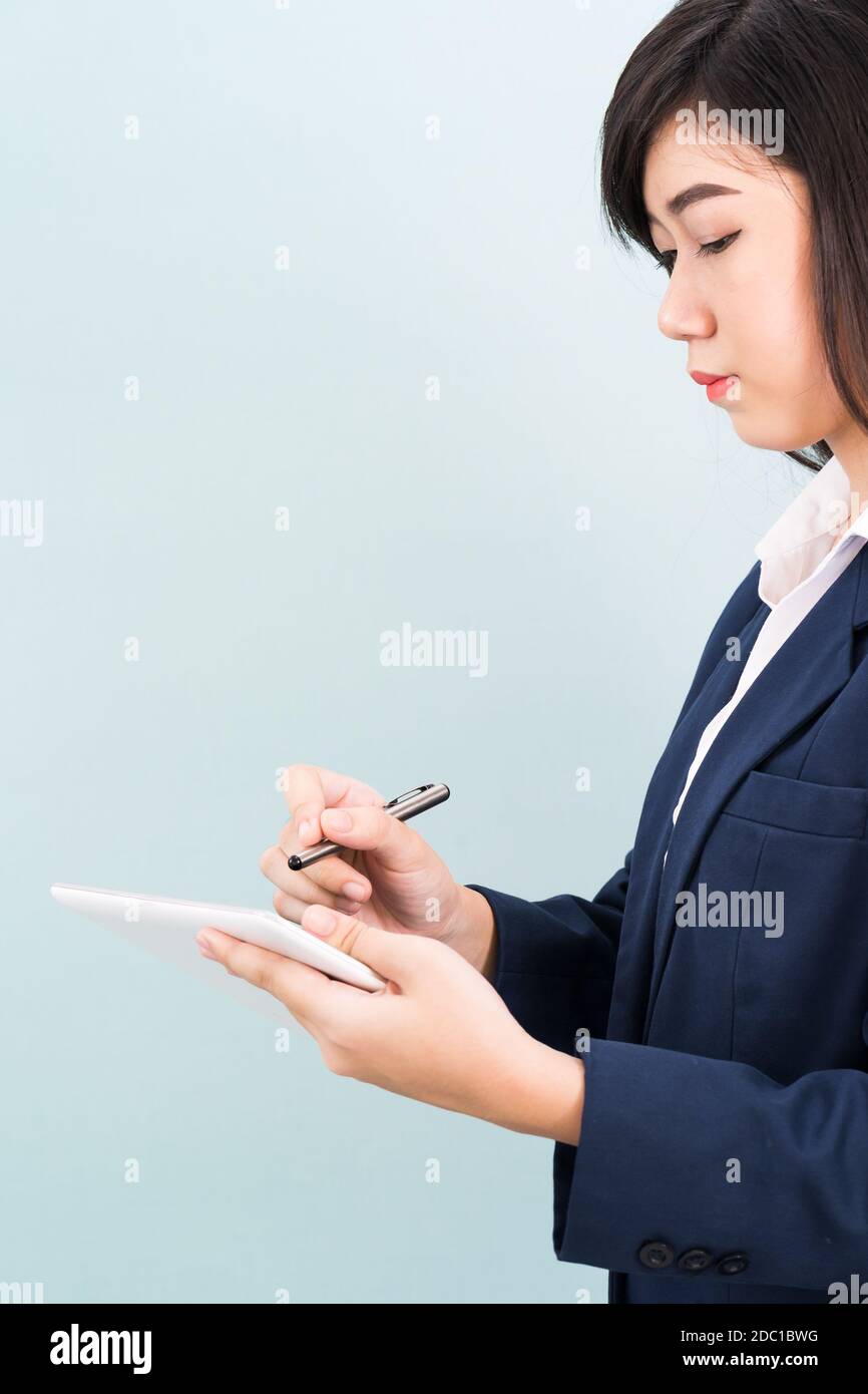 Asian teenage girl in suit using computer digital tablet isolate on ...