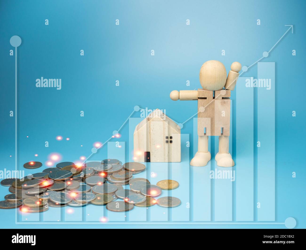 Model wooden houses and wooden dolls Stand by the pile of money With a ...