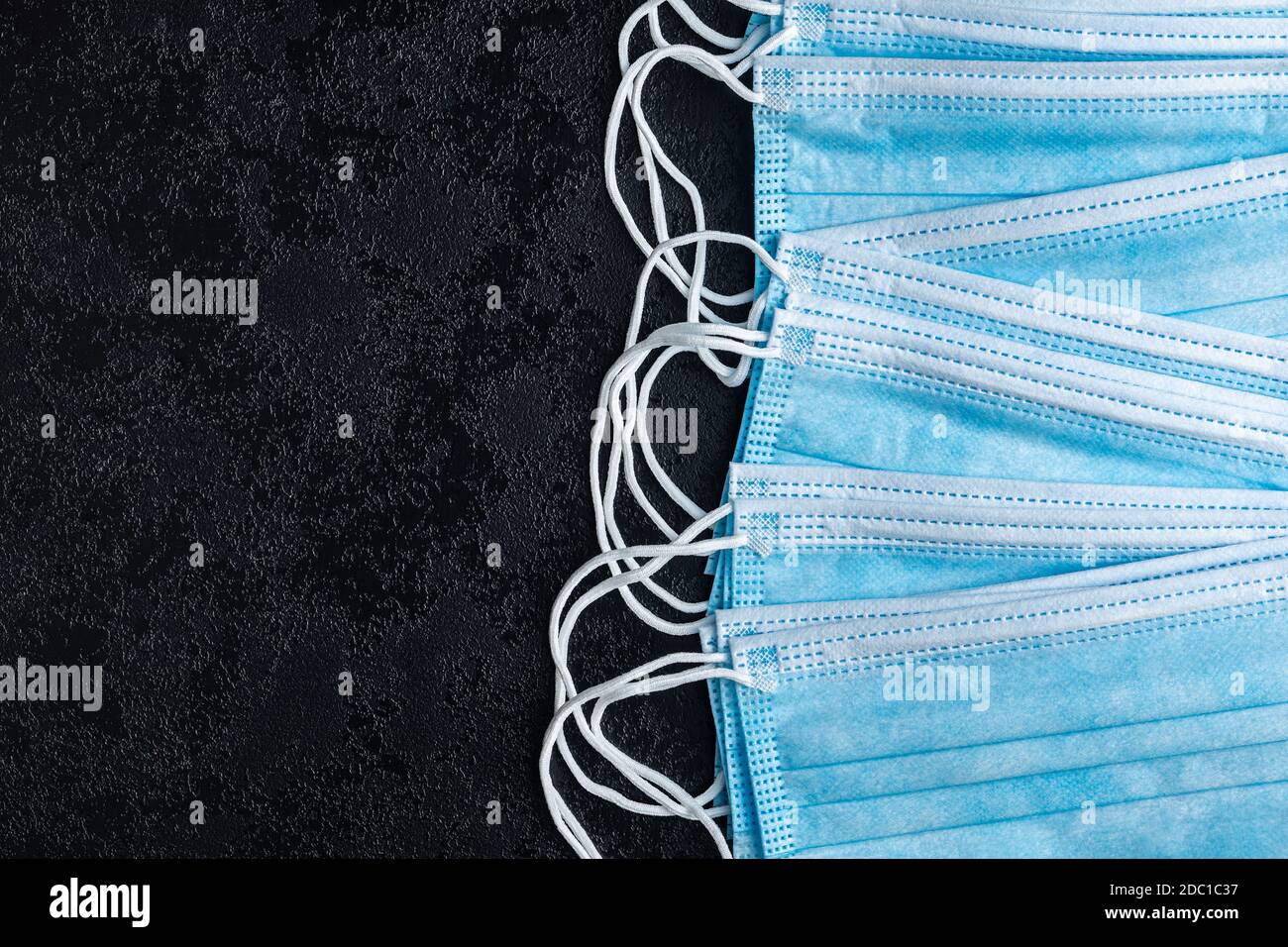 Blue paper face masks. Corona virus protection on black background ...