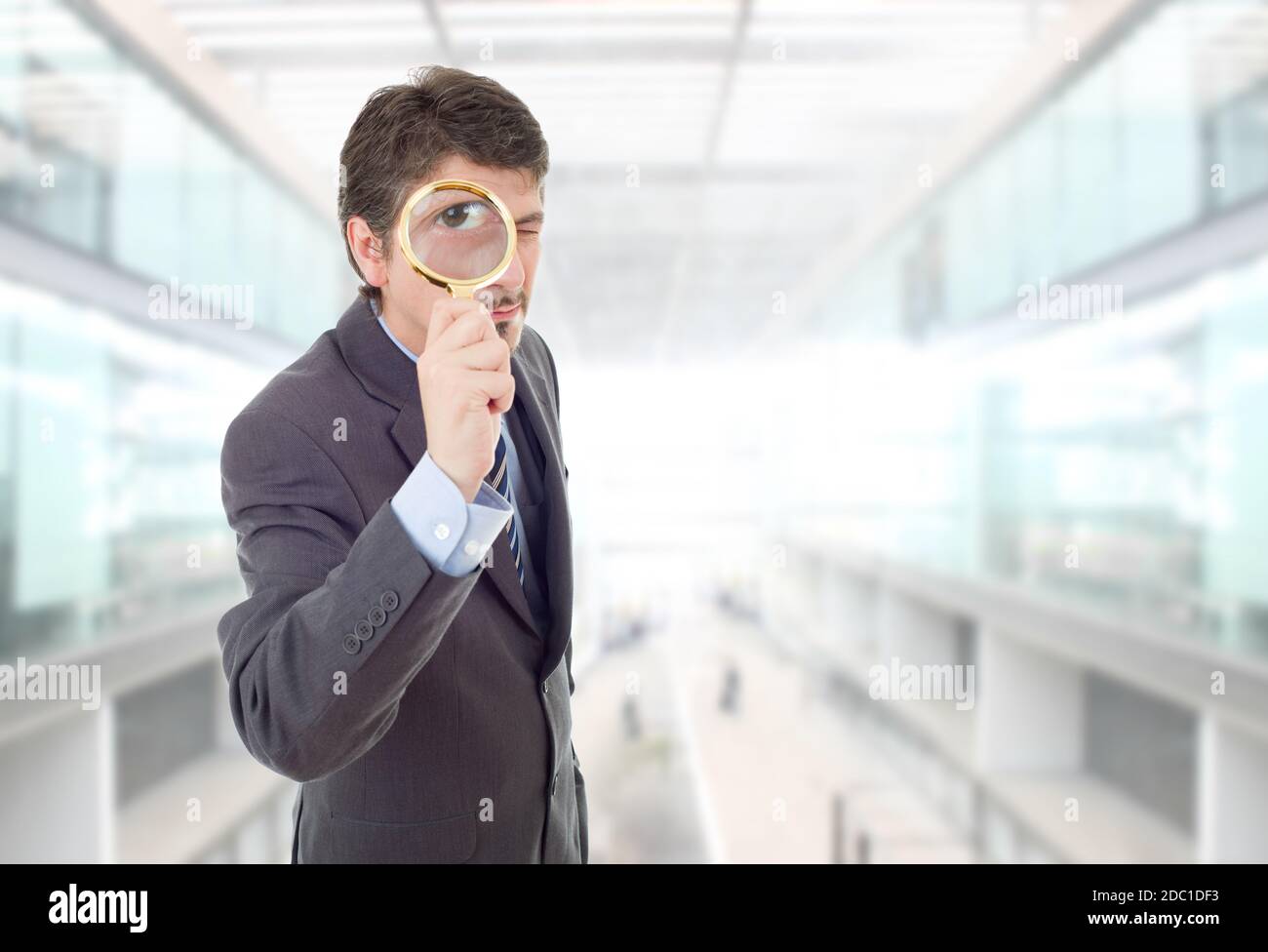business man with magnifying glass at the office Stock Photo - Alamy