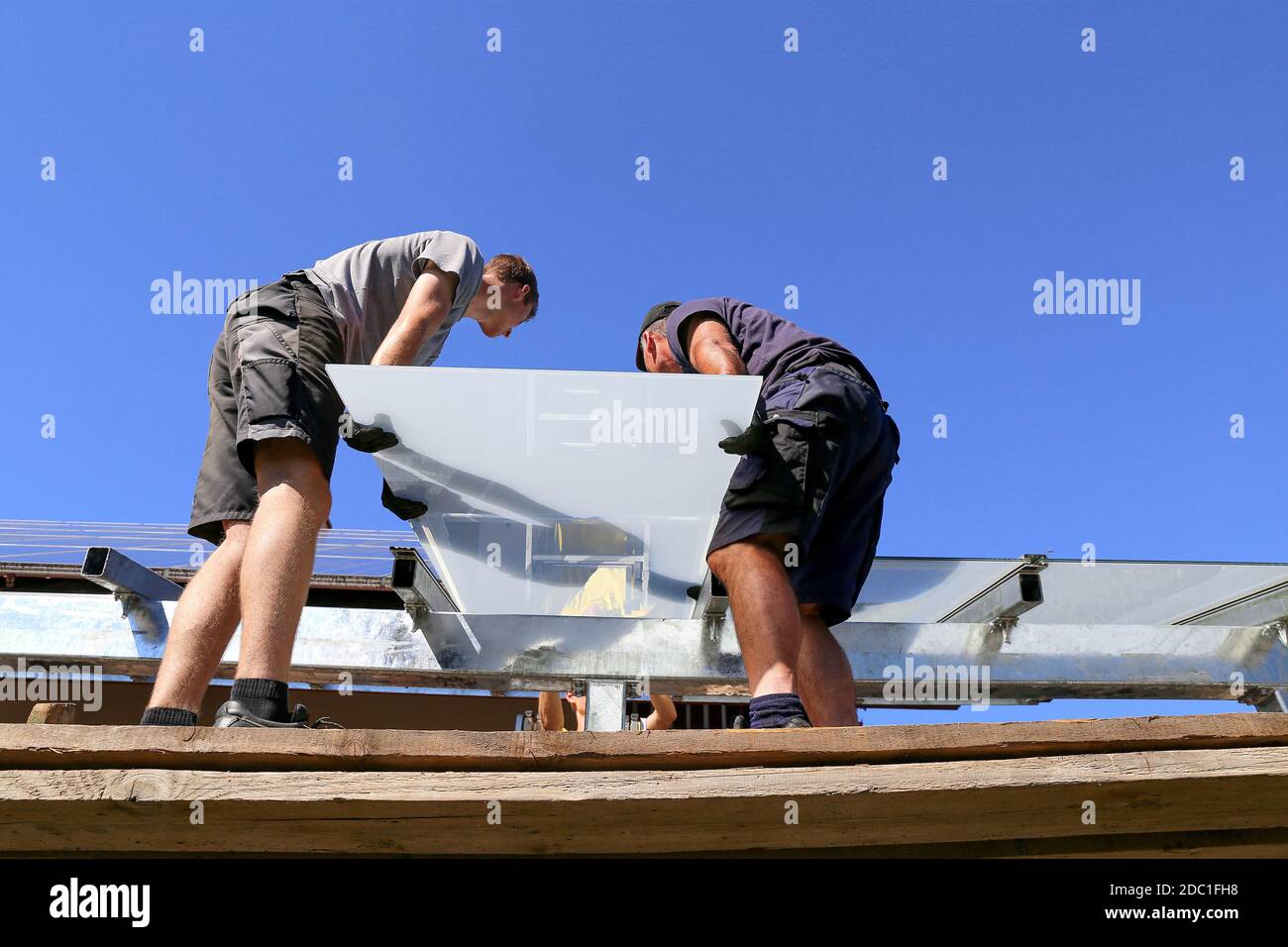 Installation of a glass roof for the terrace Stock Photo - Alamy