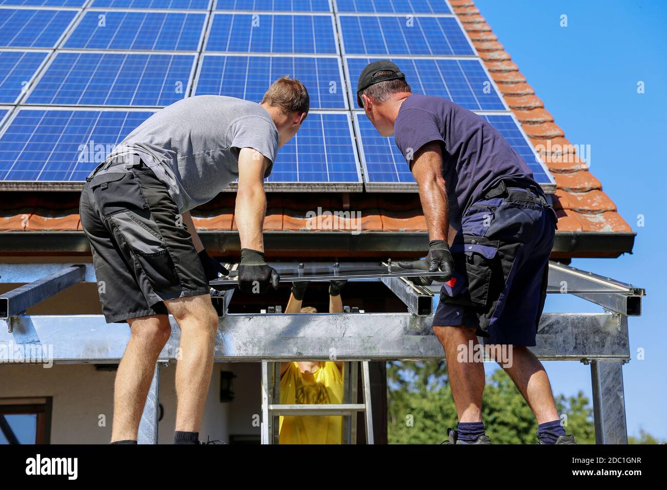 Installation of a glass roof for the terrace Stock Photo - Alamy
