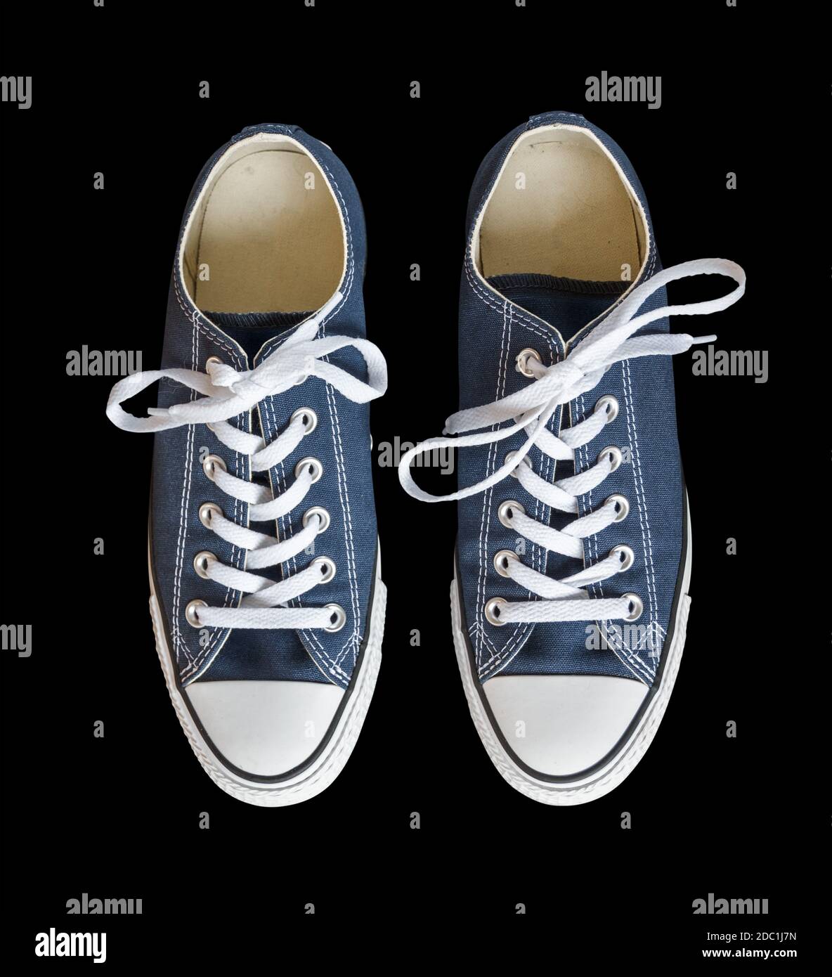Blue generic sneakers isolated on black background Stock Photo - Alamy