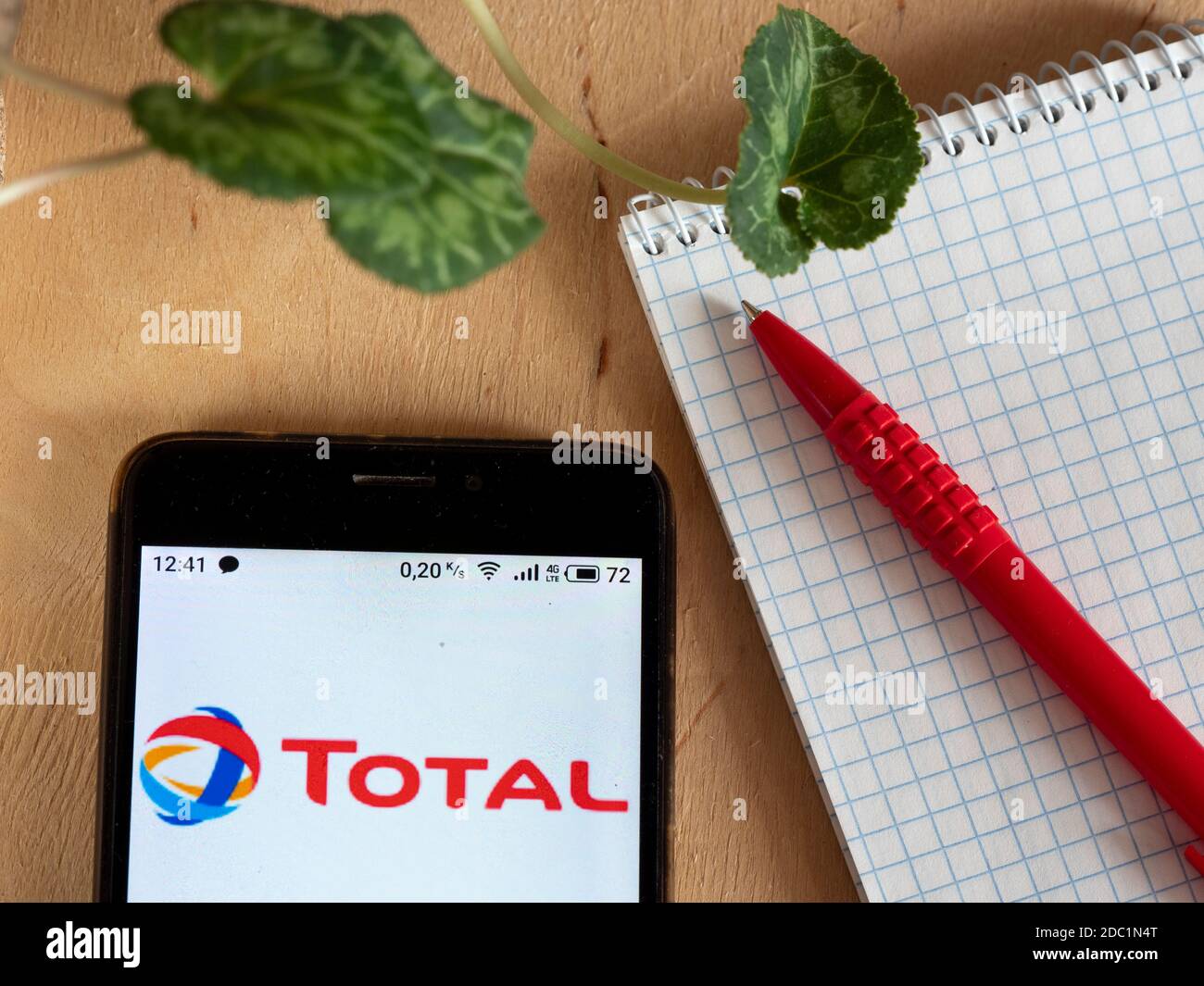 In this photo illustration a Total logo is seen displayed on a ...