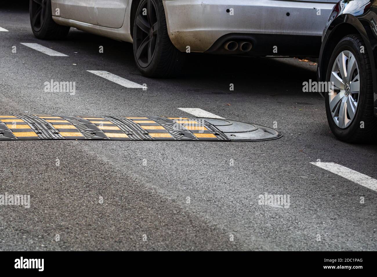 Traffic safety speed bump on an asphalt road in a parking area in ...