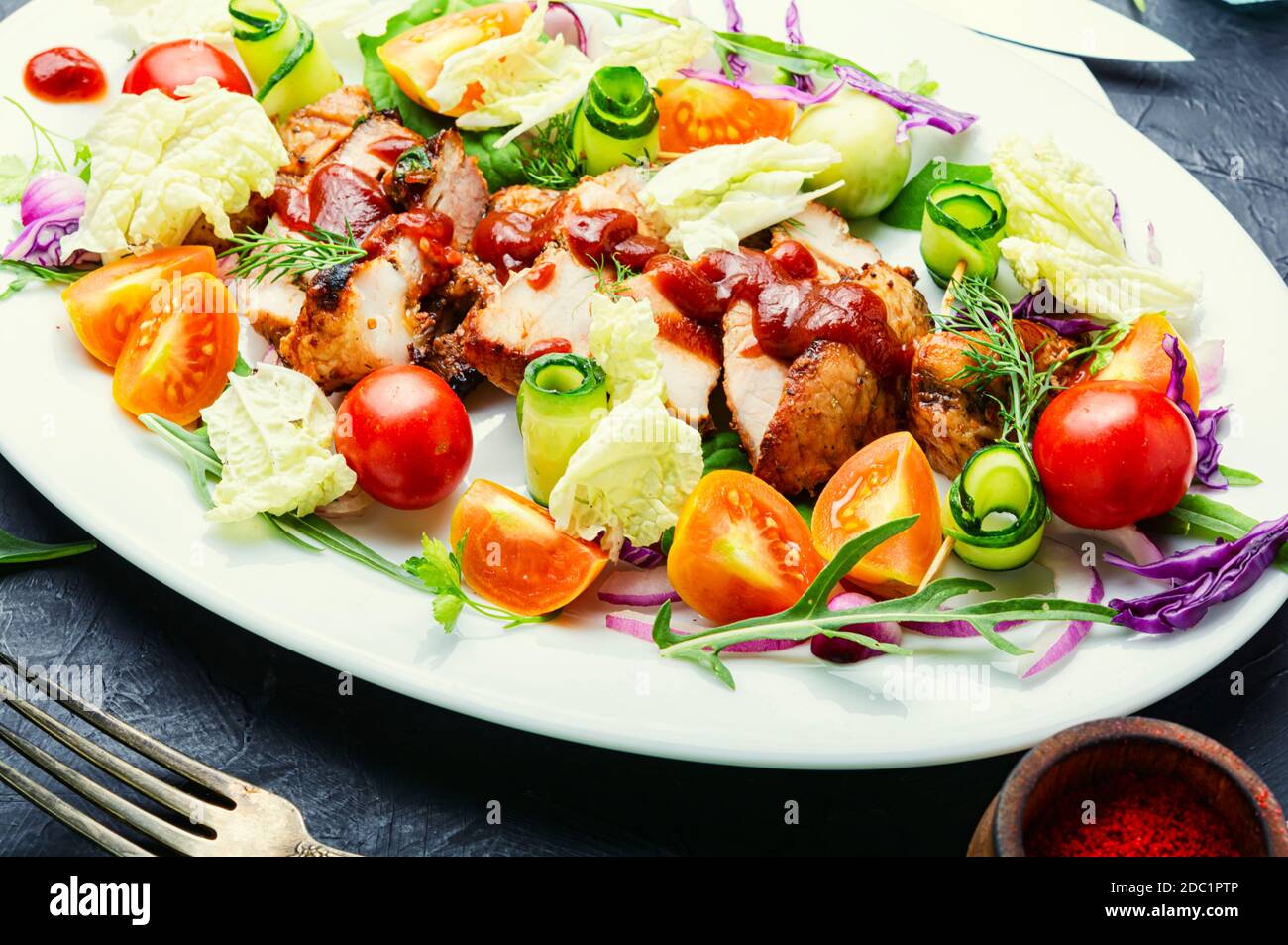 Appetizing salad with tomato,cucumber,lettuce and meat steak.Sliced ...