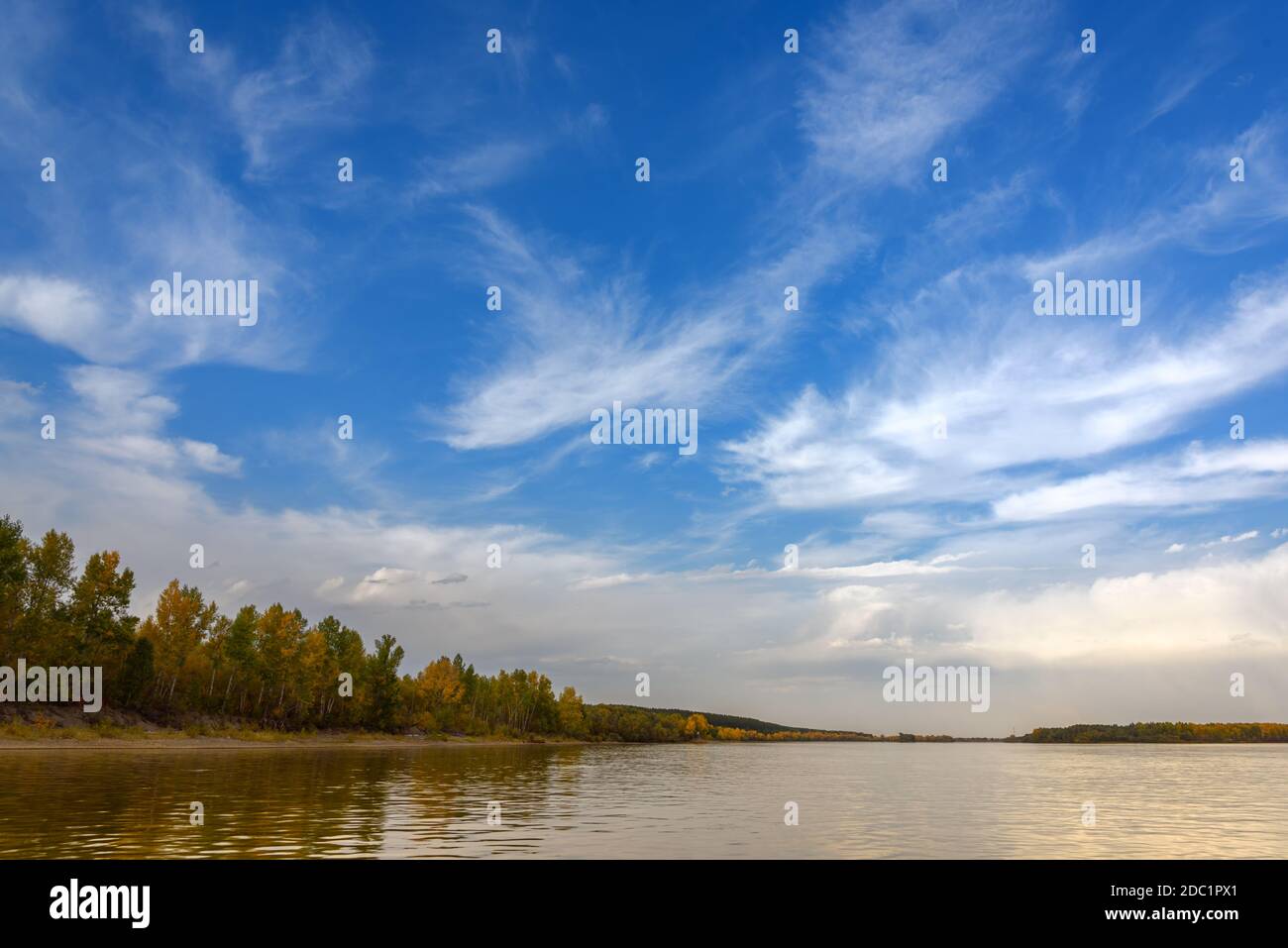 landscape on the river, blue sky with clouds, Bank edge with autumn ...