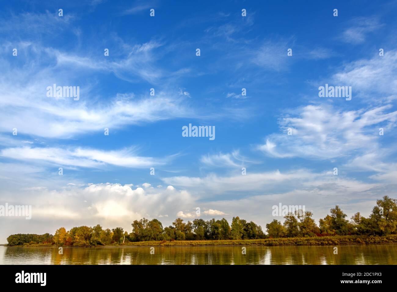 landscape on the river, blue sky with clouds, Bank edge with autumn ...