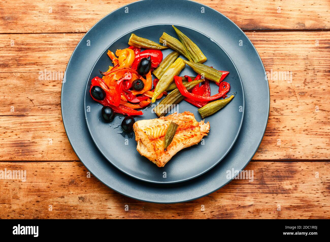 Baked fish with okra and red pepper.Fish grenadier Stock Photo - Alamy