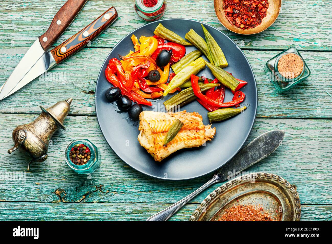 Fish grenadier baked with vegetables.Seafood on wooden background Stock ...
