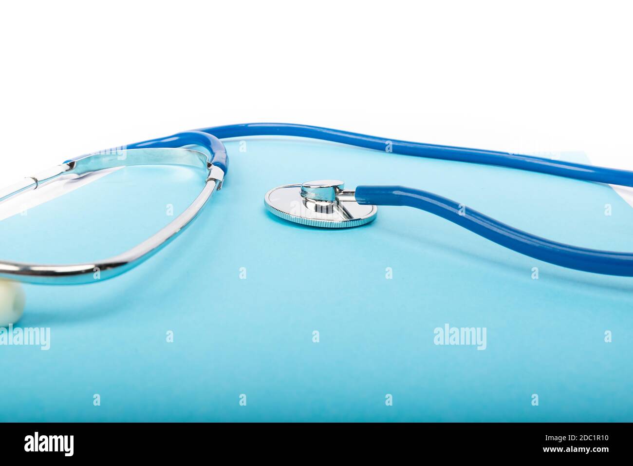 medical record and blue stethoscope close-up on white background in ...