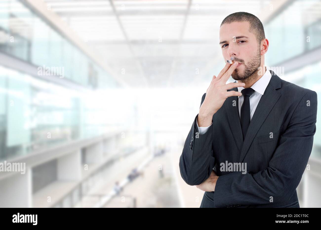 businessman smoking at the office Stock Photo - Alamy