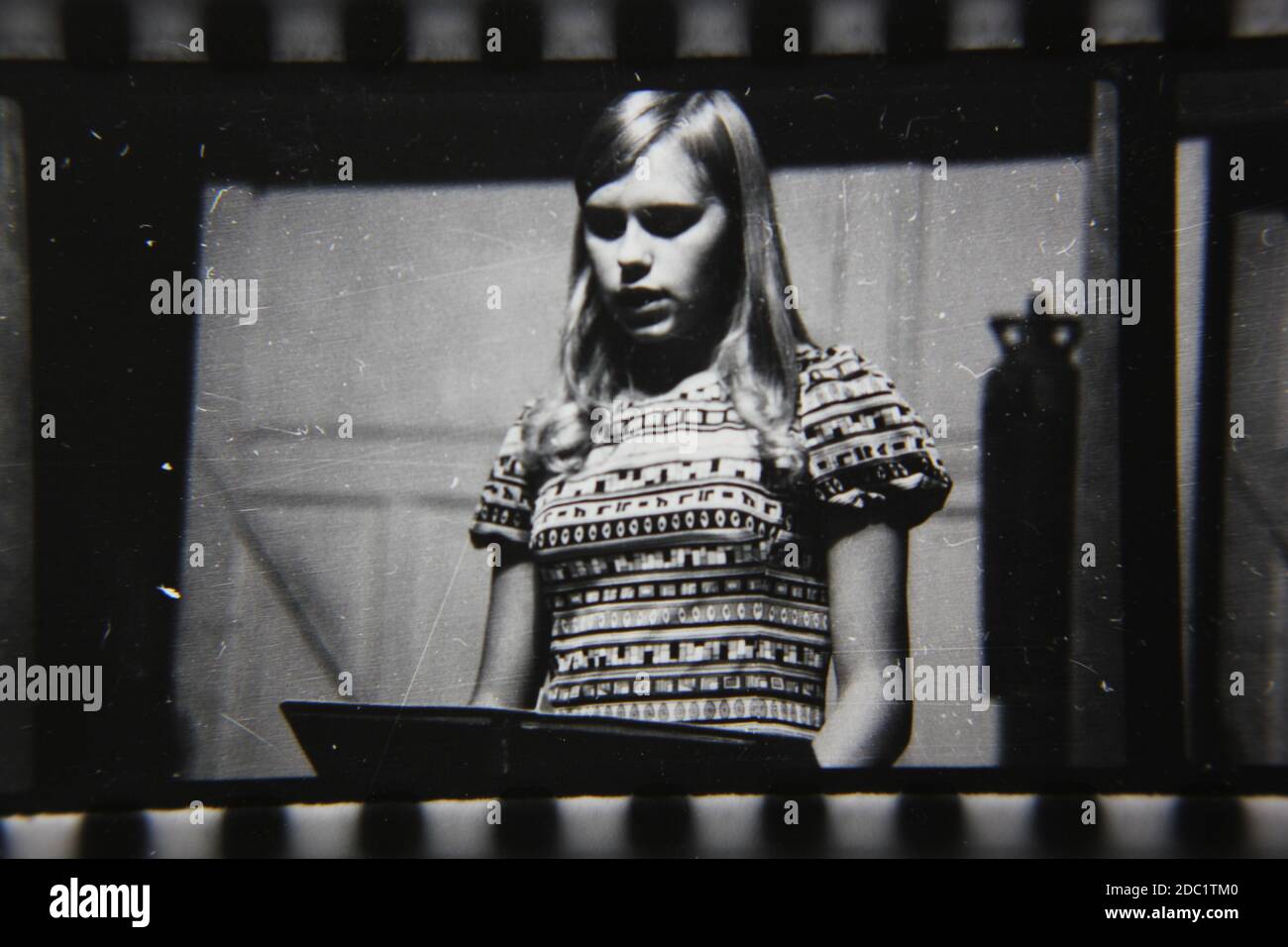 Fine 1970s vintage black and white photography of a young woman giving ...