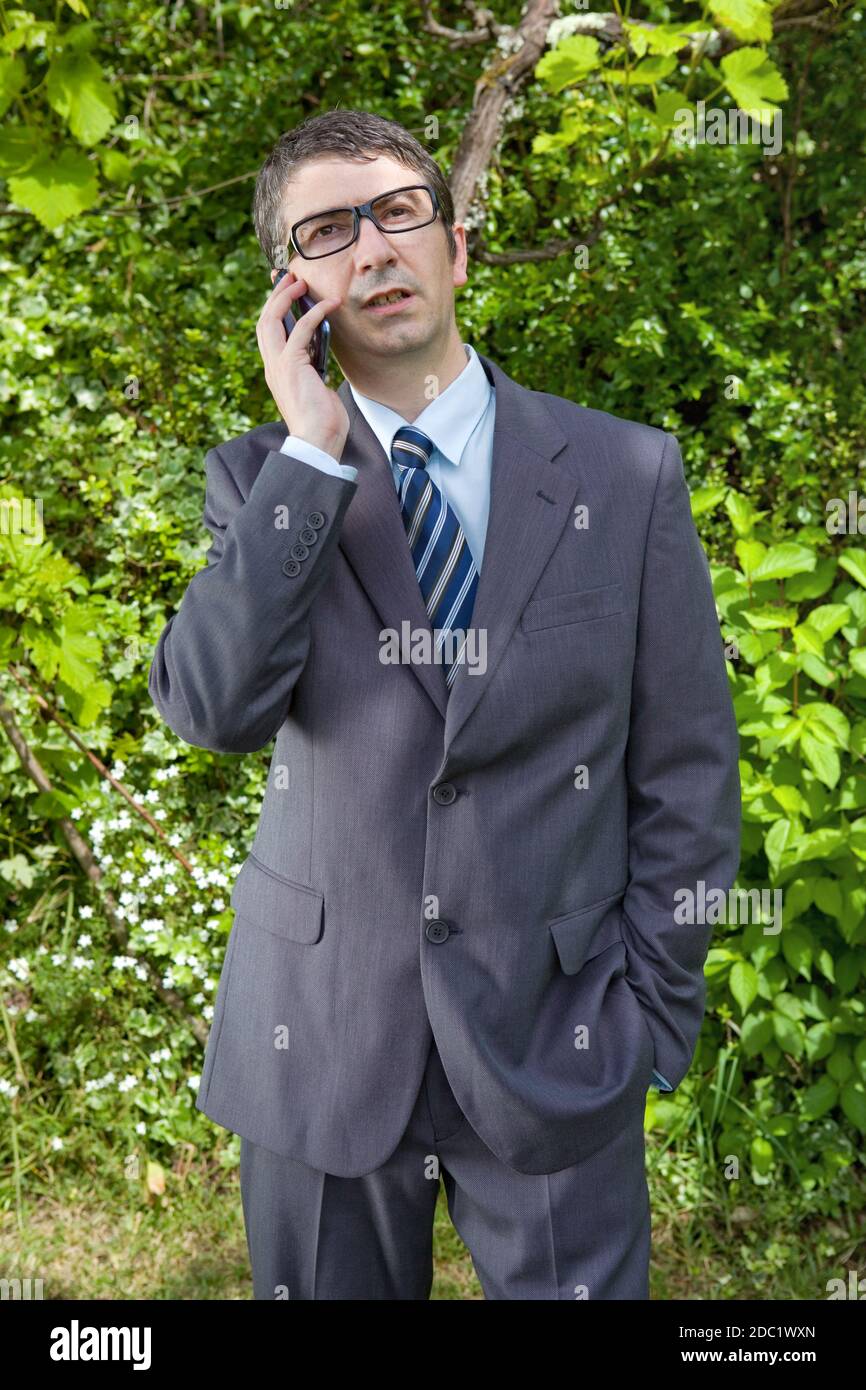 Happy businessman outdoor talking through mobile phone Stock Photo - Alamy