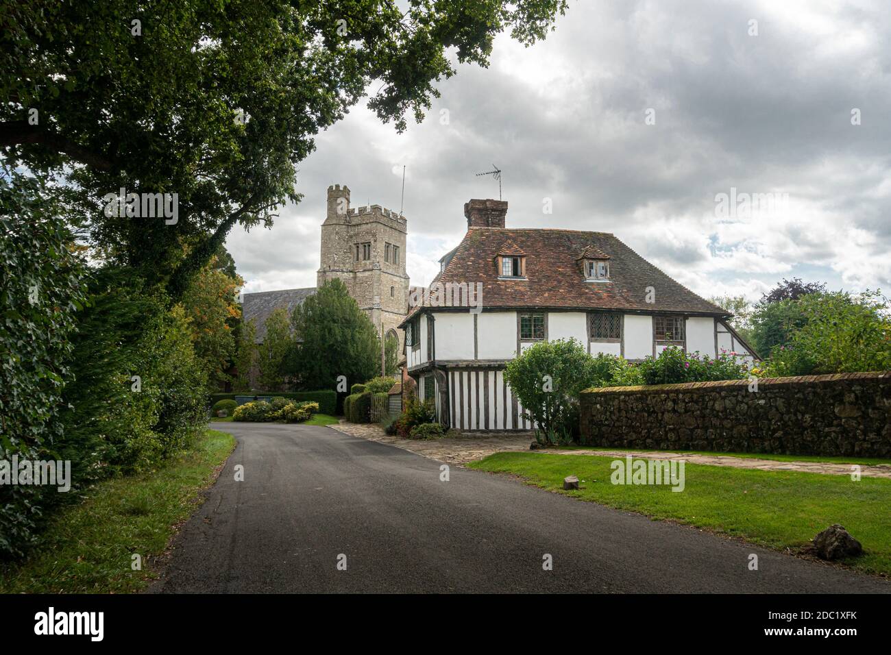 Street view of the church and ancient timber-framed cottage in the ...