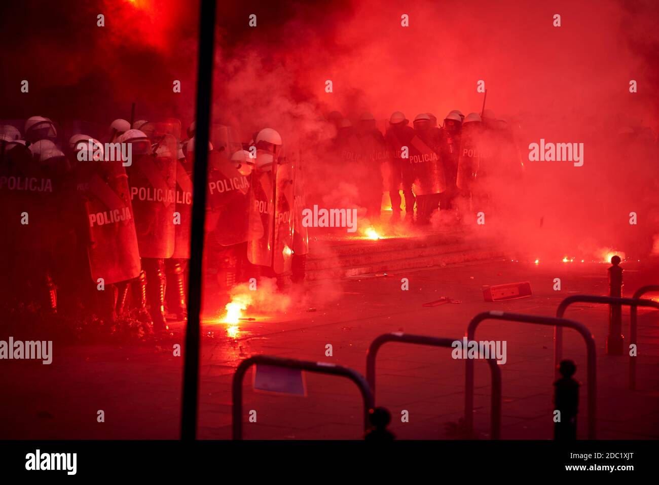 Police cordon and red flares during street protest Stock Photo - Alamy