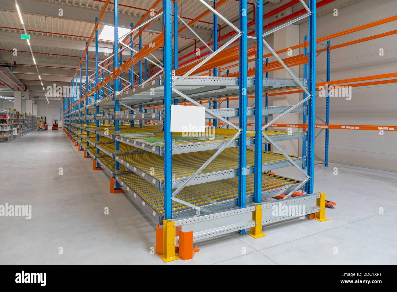 Gravity Flow Rack Shelving in Distribution Warehouse Stock Photo - Alamy