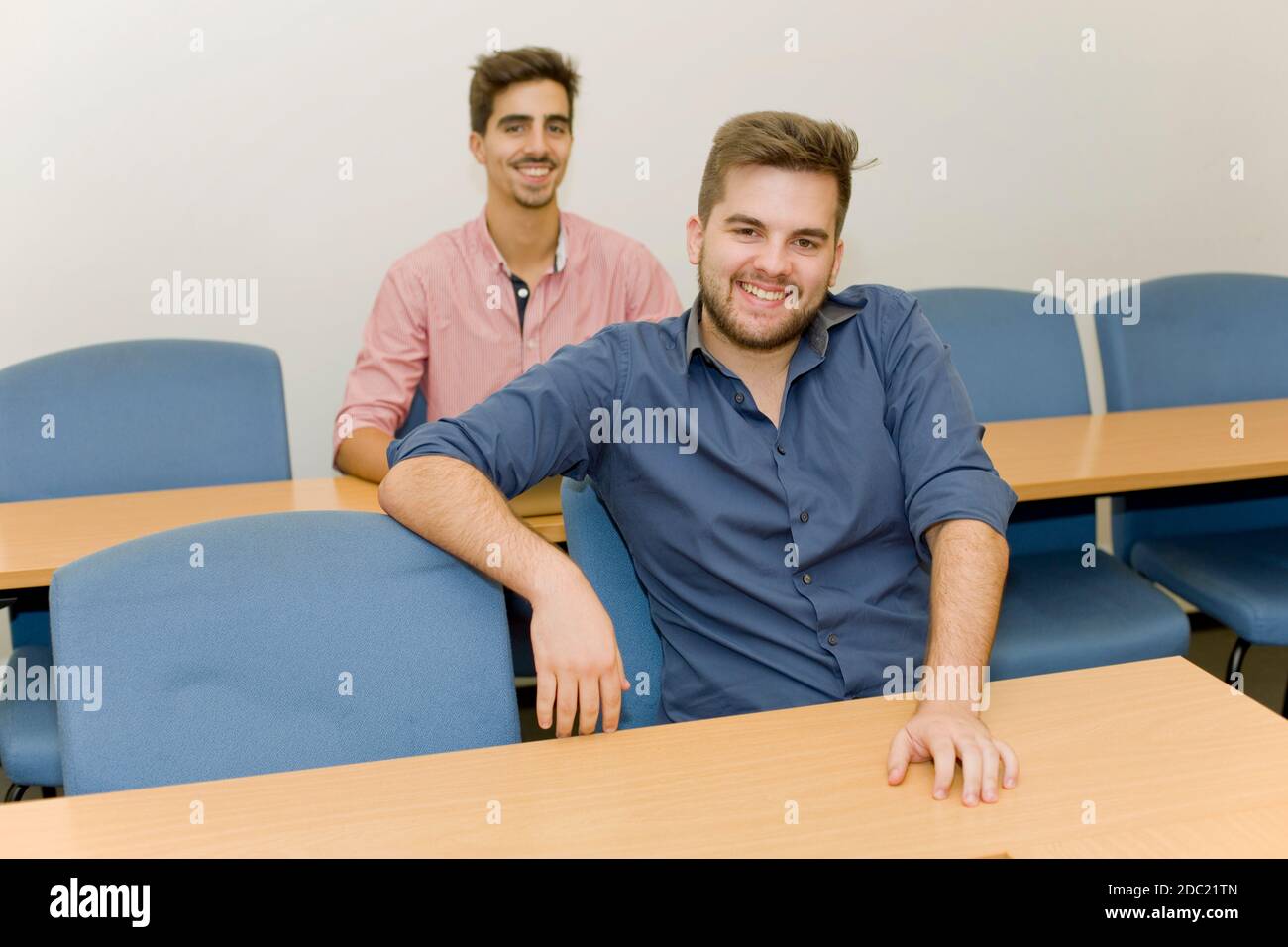 two young happy men at the classroom Stock Photo - Alamy