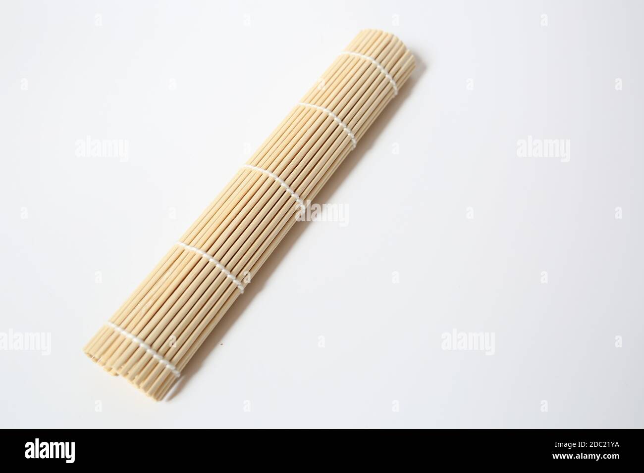 Bamboo mat for making a Japanese sushi isolated on a white background ...
