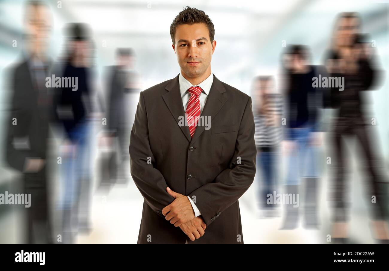 Young business man portrait smilling, among out of focus people Stock ...