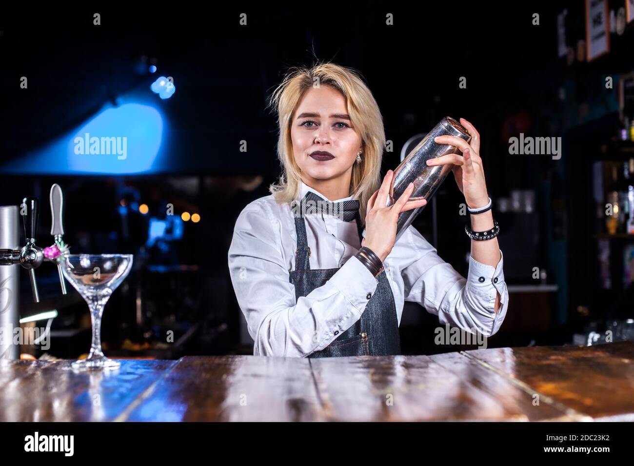 Professional woman tapster surprises with its skill bar visitors in pub Stock Photo - Alamy
