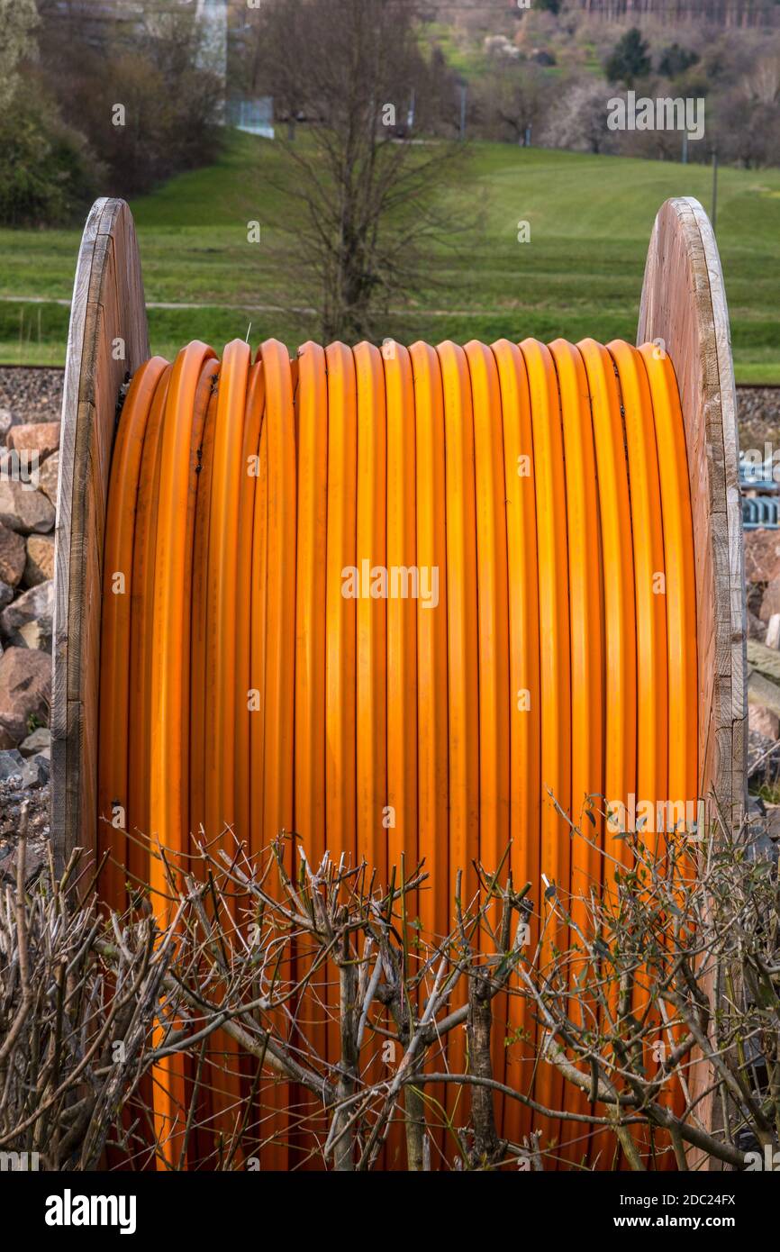 Big orange cable reel outside on the ground Stock Photo - Alamy
