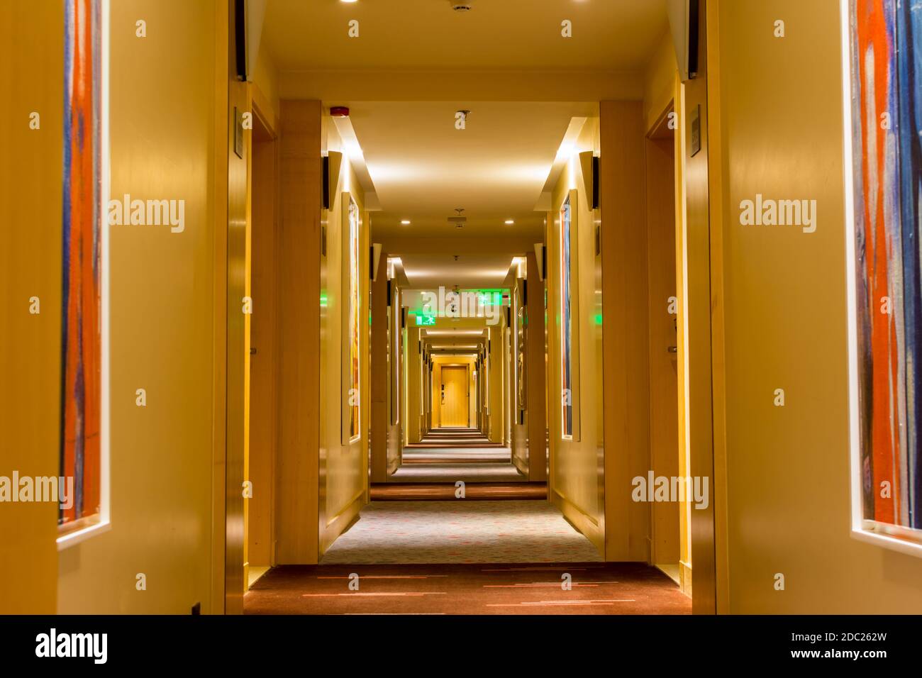 Golden corridor with carpet and closed doors at the hotel Stock Photo ...