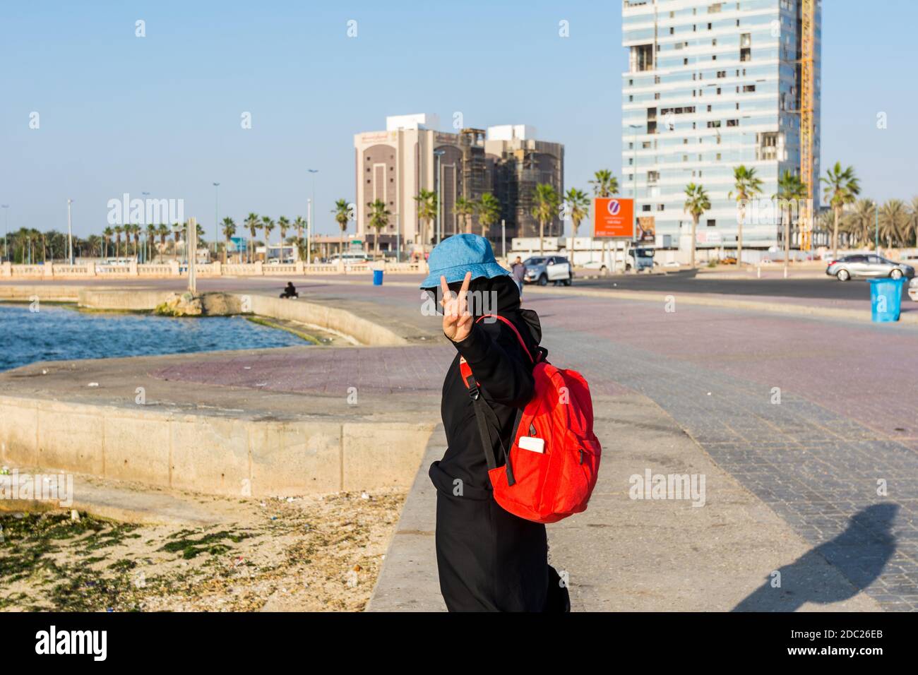 A Female tourist with red backpack wearing hijab in Jeddah Corniche, 30 ...