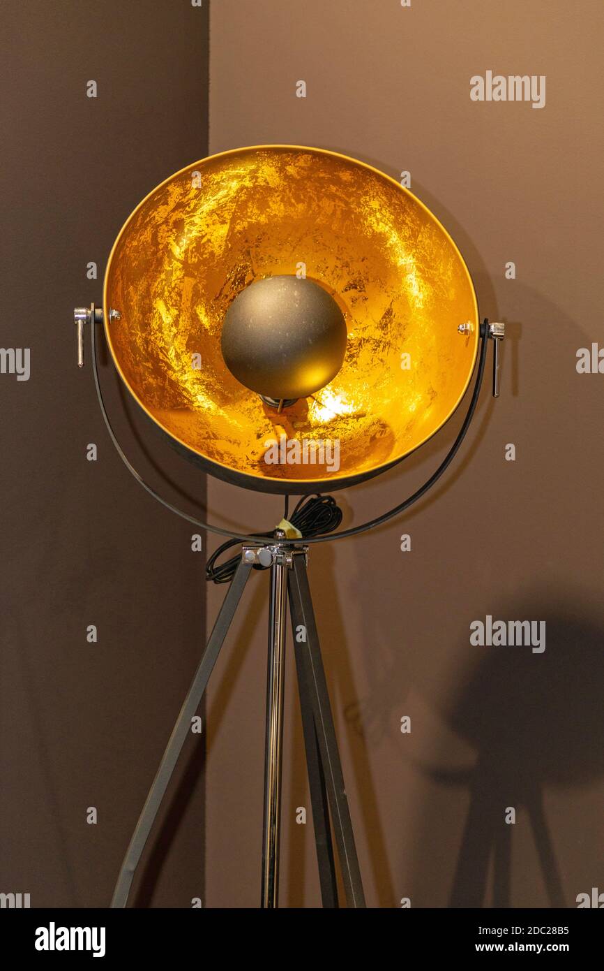 Gold Reflector Lamp at Tripod in Corner Stock Photo - Alamy