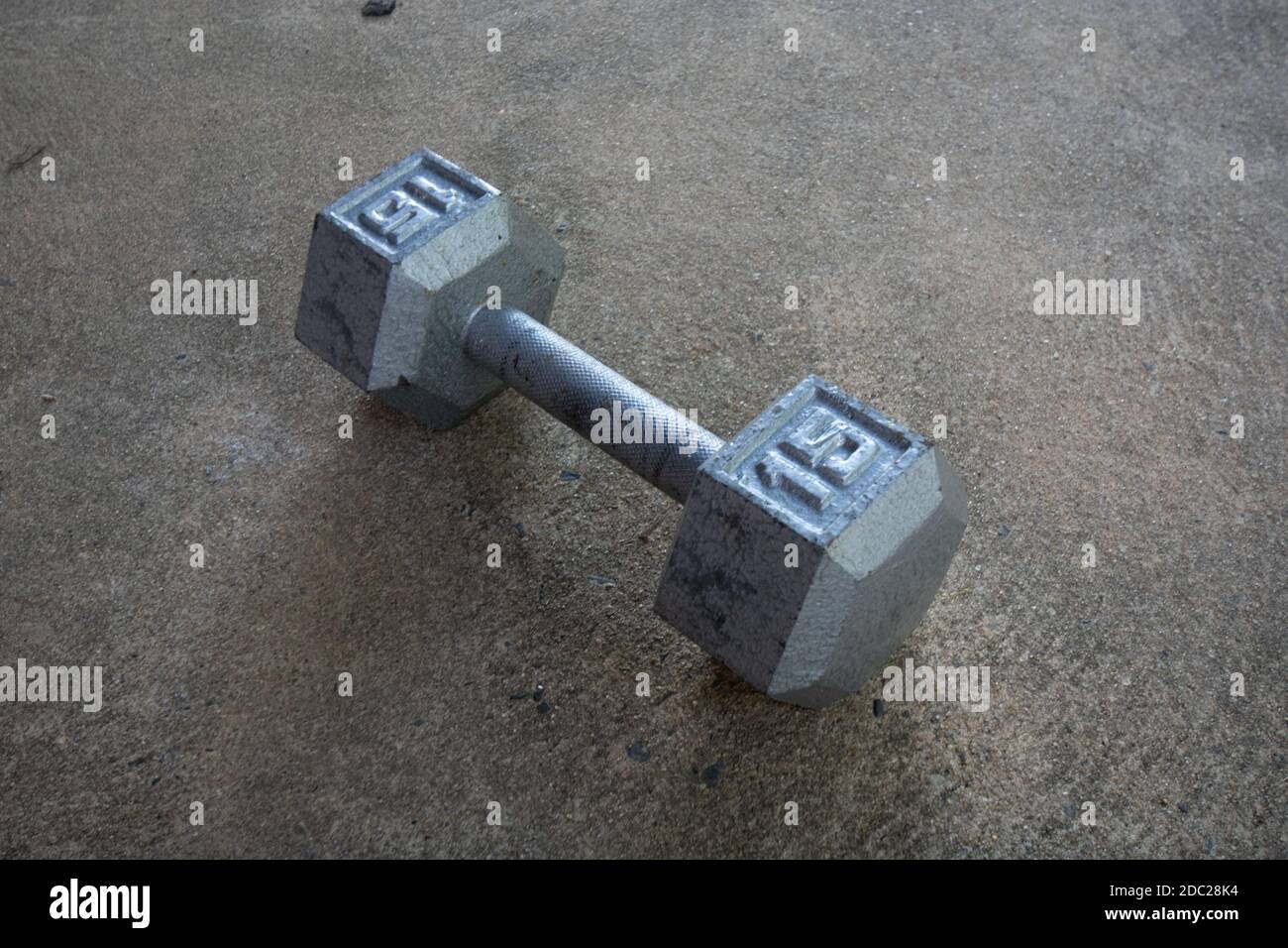 An Old Silver Fifteen Pound Weight on Concrete Stock Photo - Alamy
