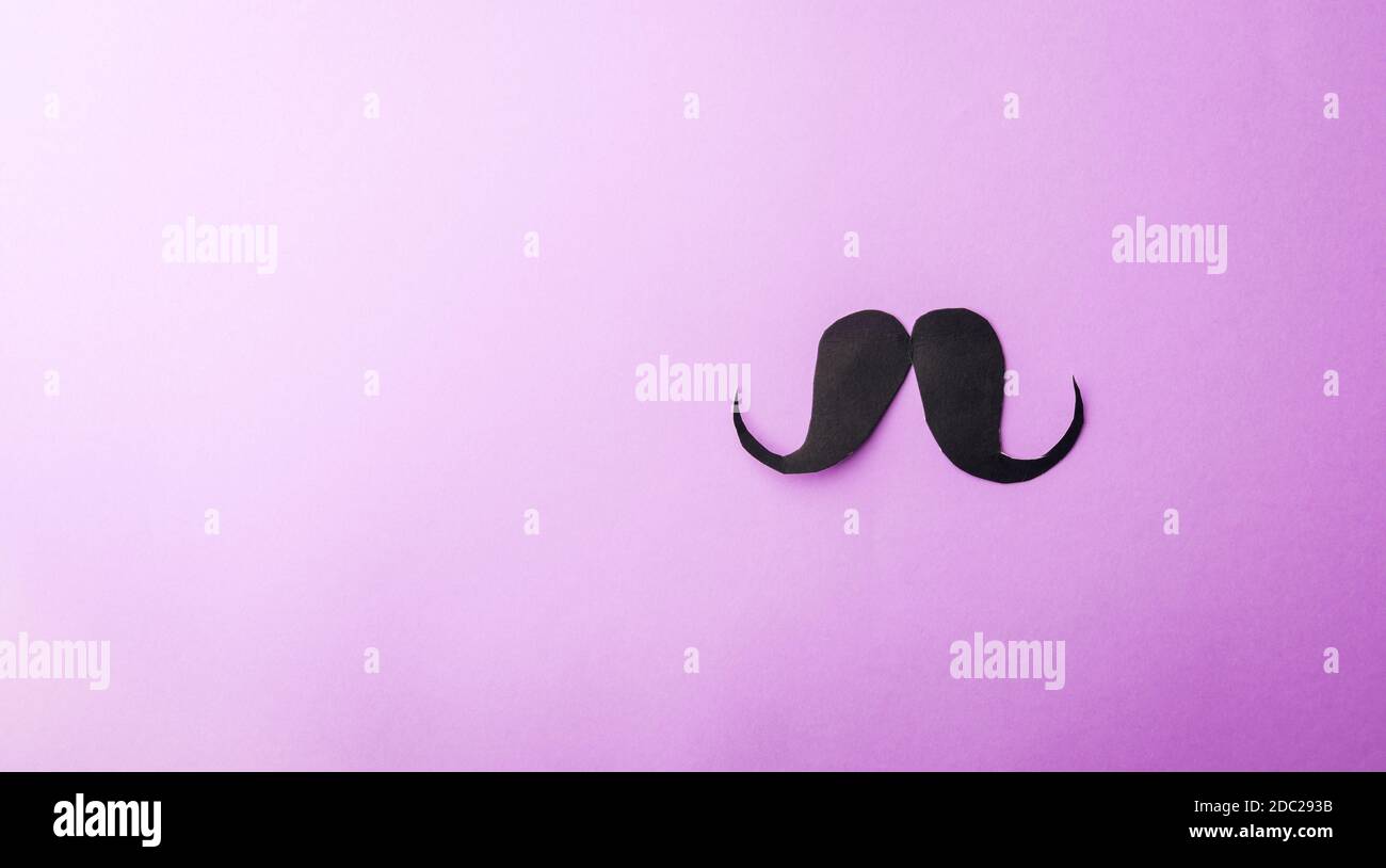 Black mustache paper, studio shot isolated on purple background ...