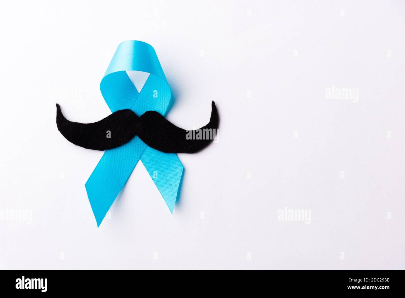 Black mustache paper and light blue ribbon, studio shot isolated on ...