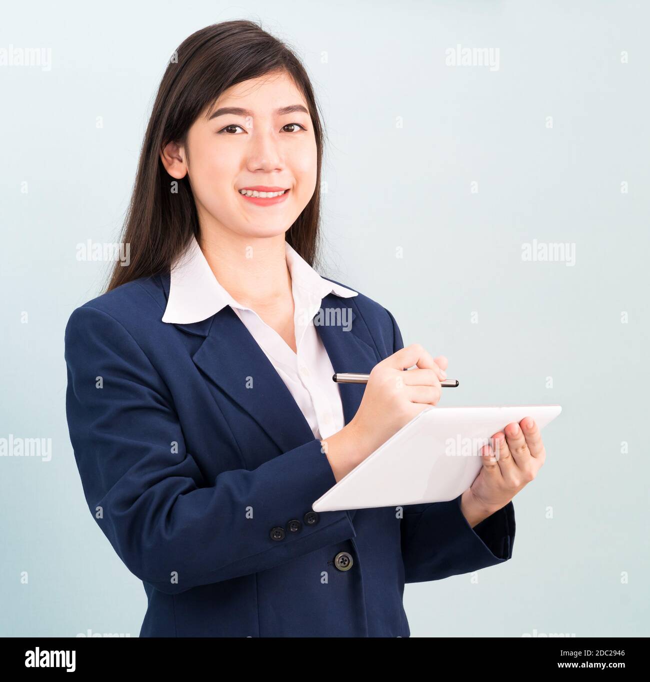 Asian teenage girl in suit using computer digital tablet isolate on ...