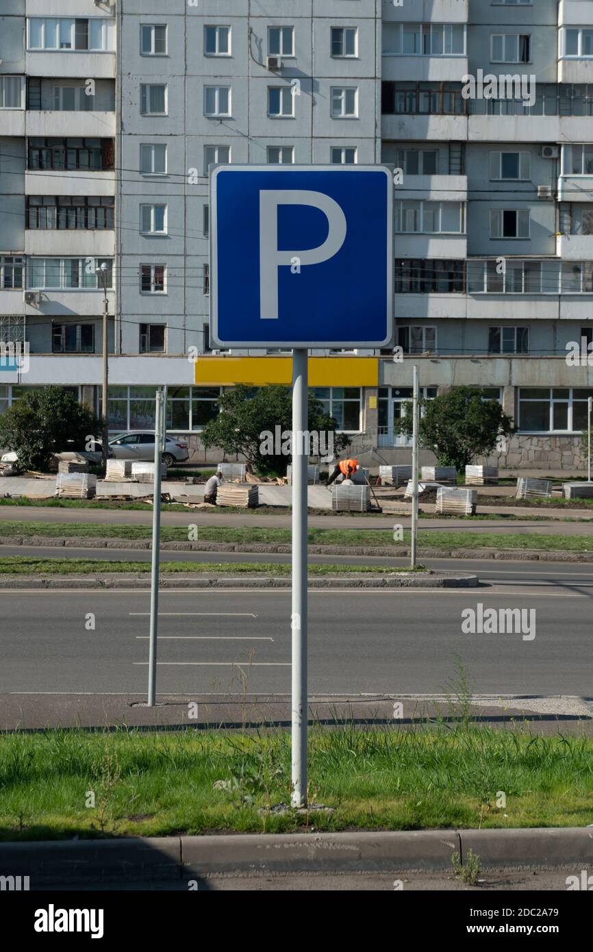 Car parking road sign. A blue square sign on a post with a white P ...