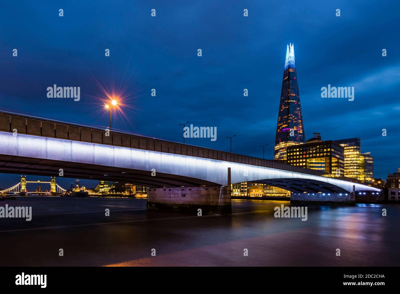 Lights at dusk over the River Thames at London Bridge and The Shard ...