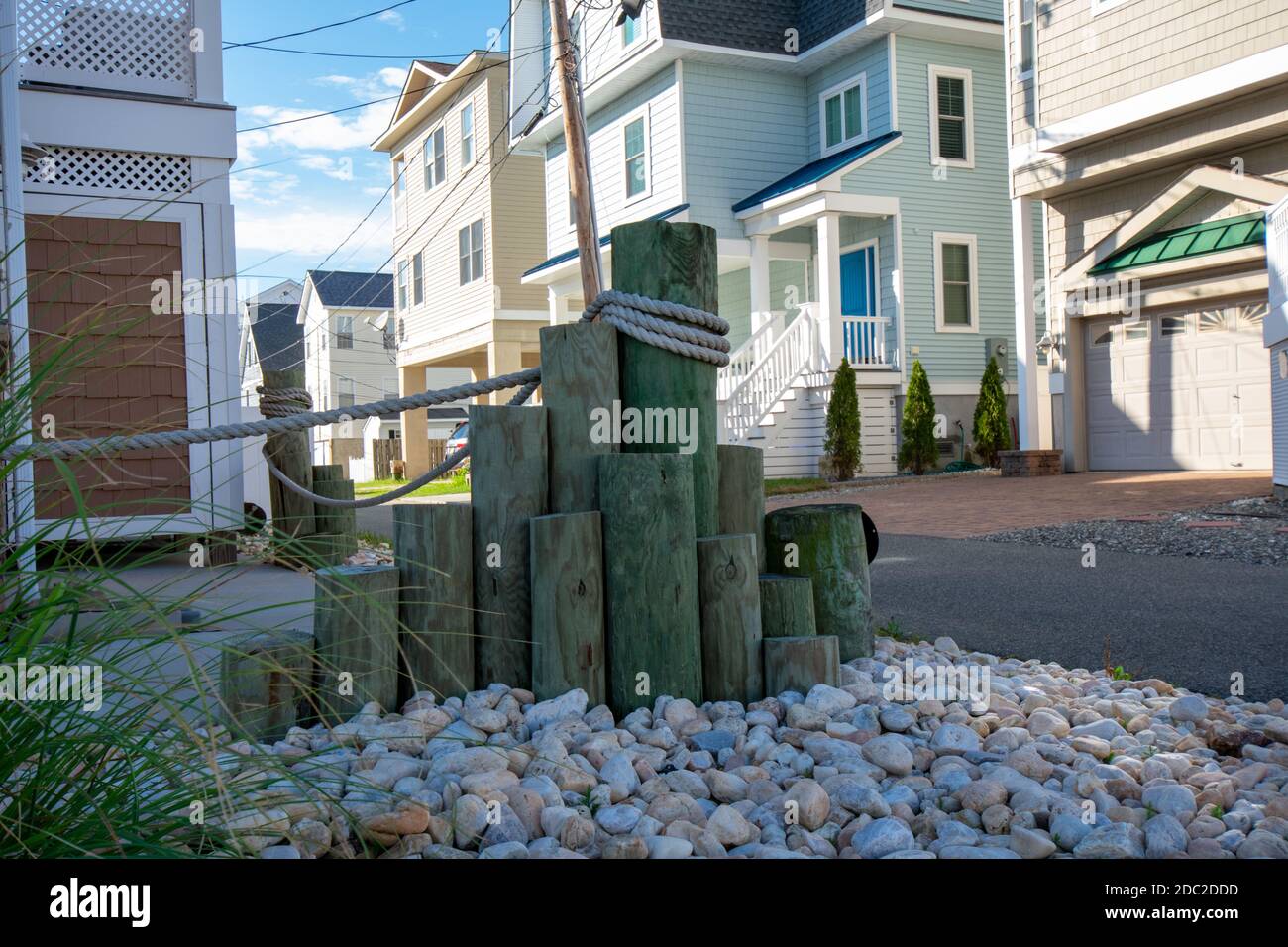 Wooden Beach Pilings with a Rope in a Rock Bed in the Yard of a Shore ...