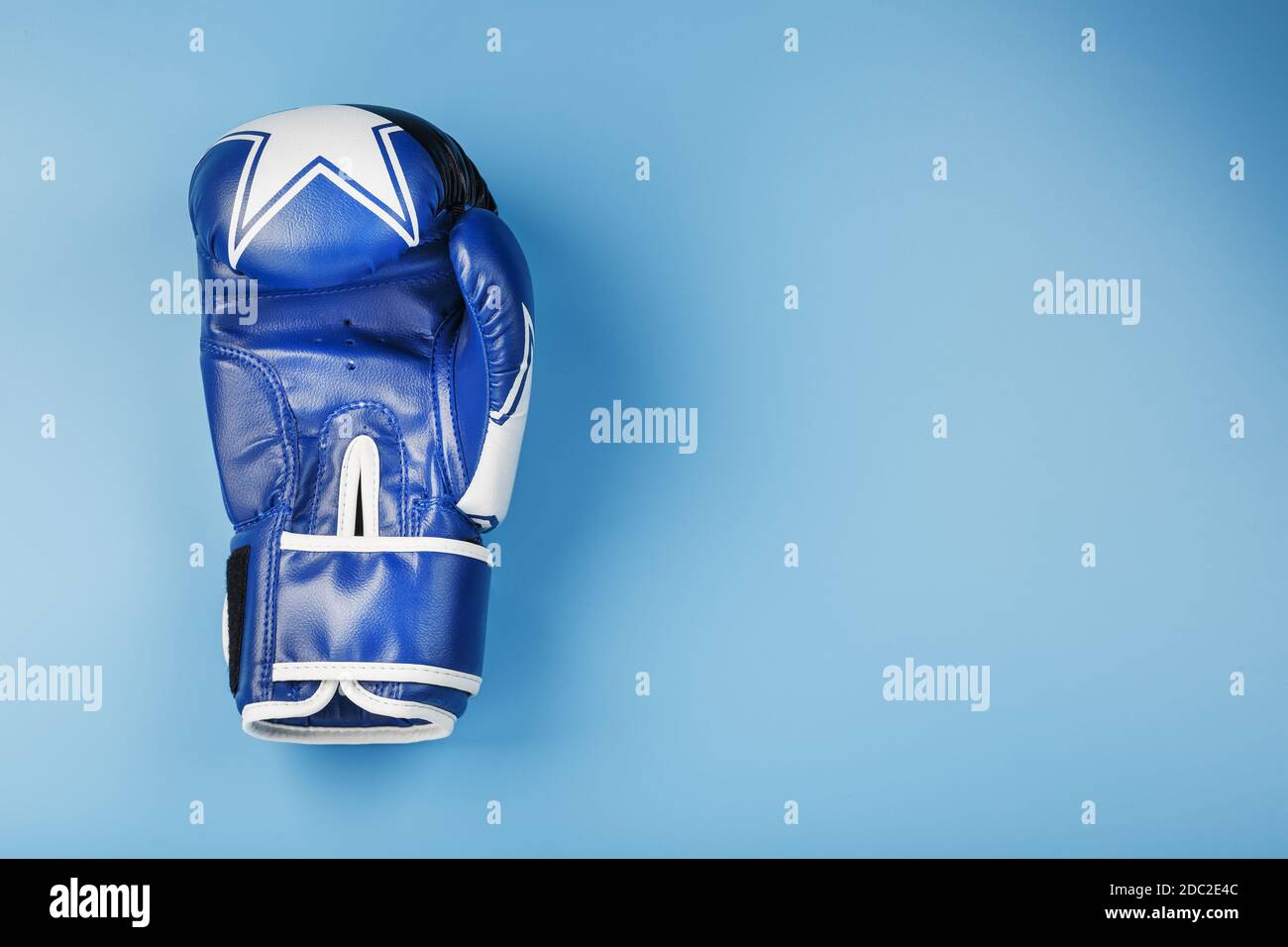 Blue Boxing glove on a blue background, free space. The concept of ...