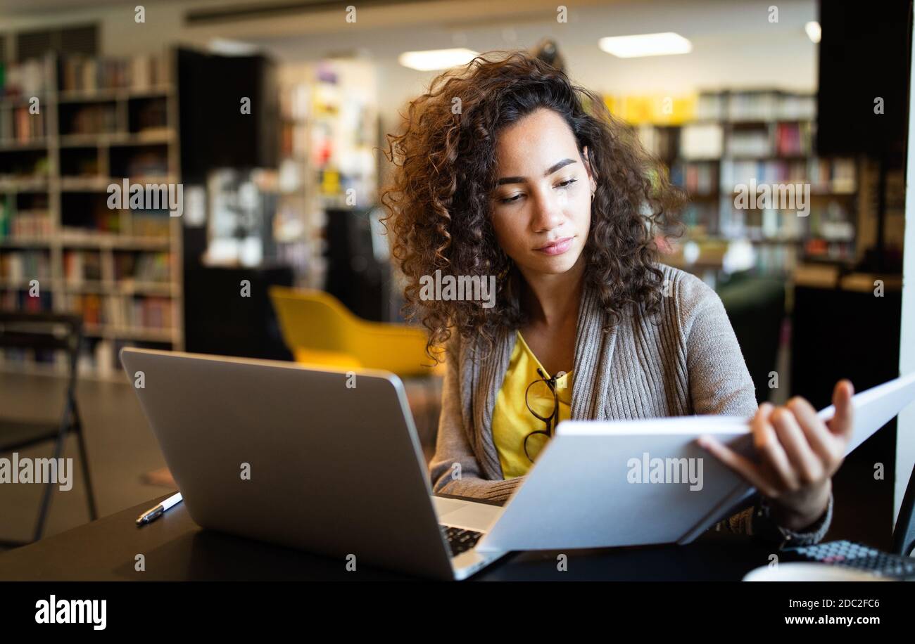 Young beautiful student girl working, learning in college library Stock ...