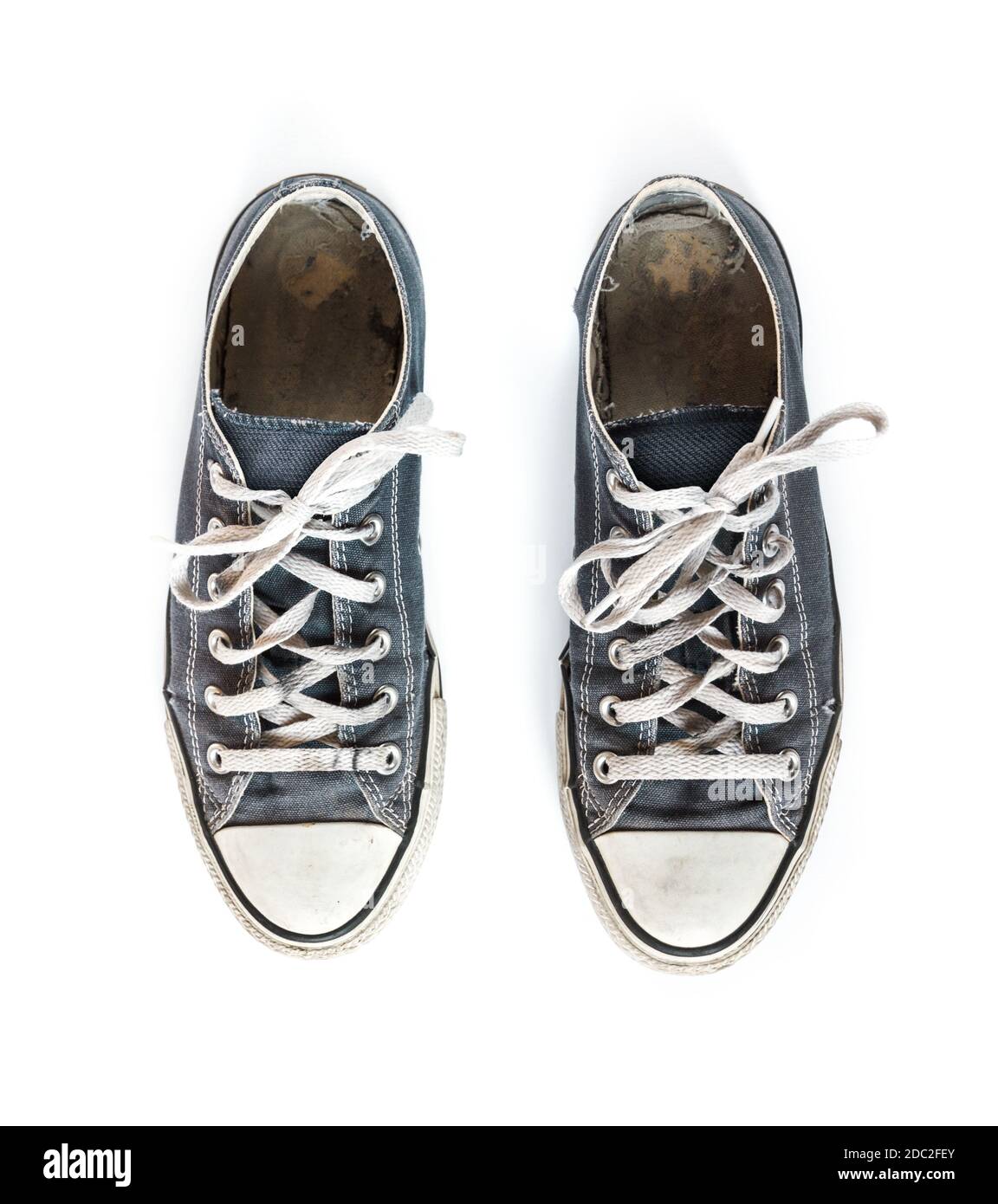 Old blue generic sneakers isolated on white background Stock Photo - Alamy