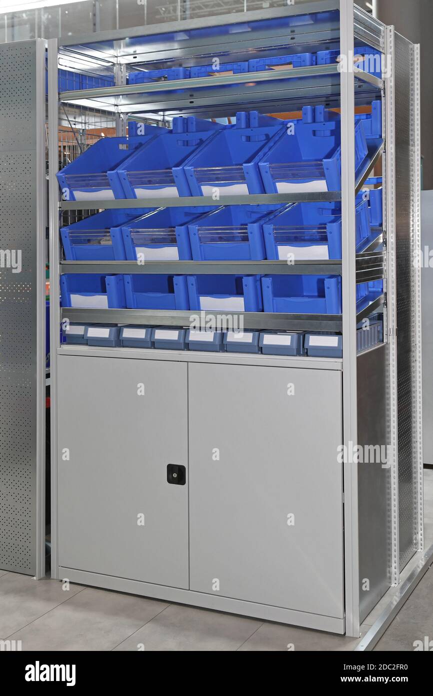 Storage shelf with bins and trays in warehouse Stock Photo - Alamy