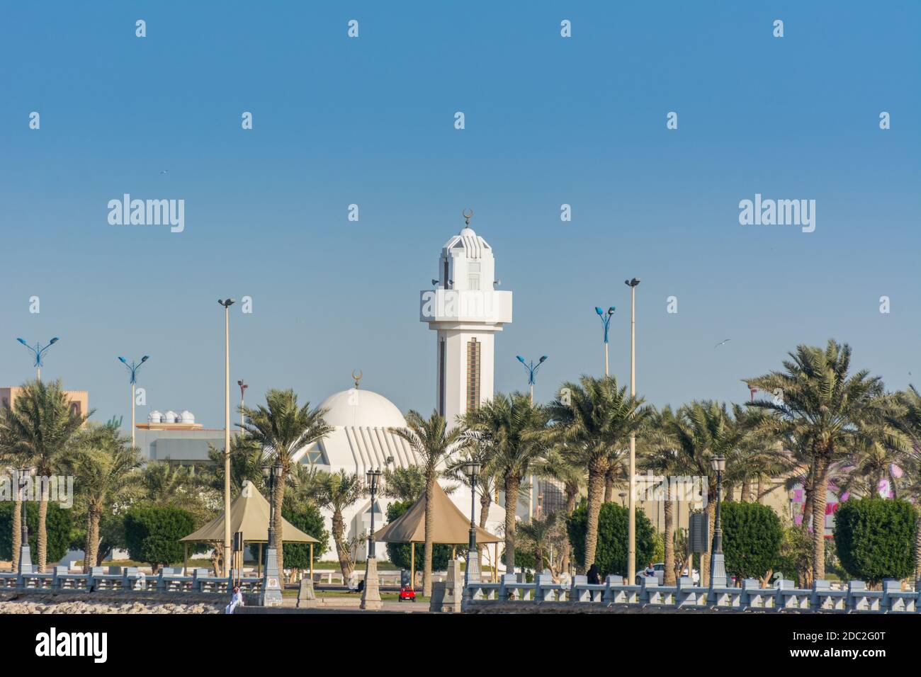 A common small mosque, Al Essa and Al Dowayan Mosque, with palm tree in ...