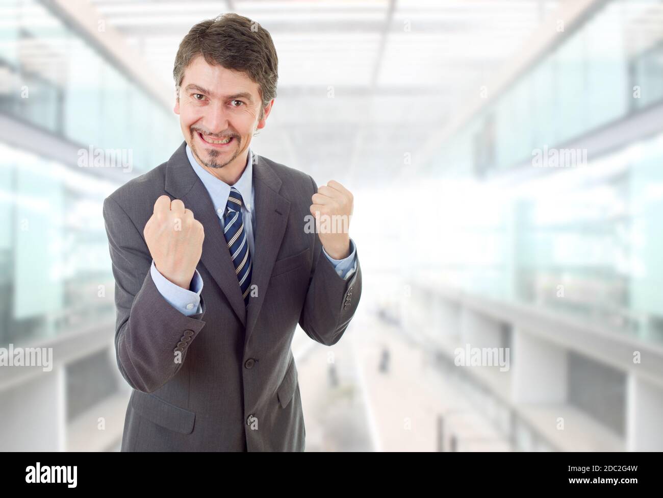 happy business man winning, at the office Stock Photo - Alamy