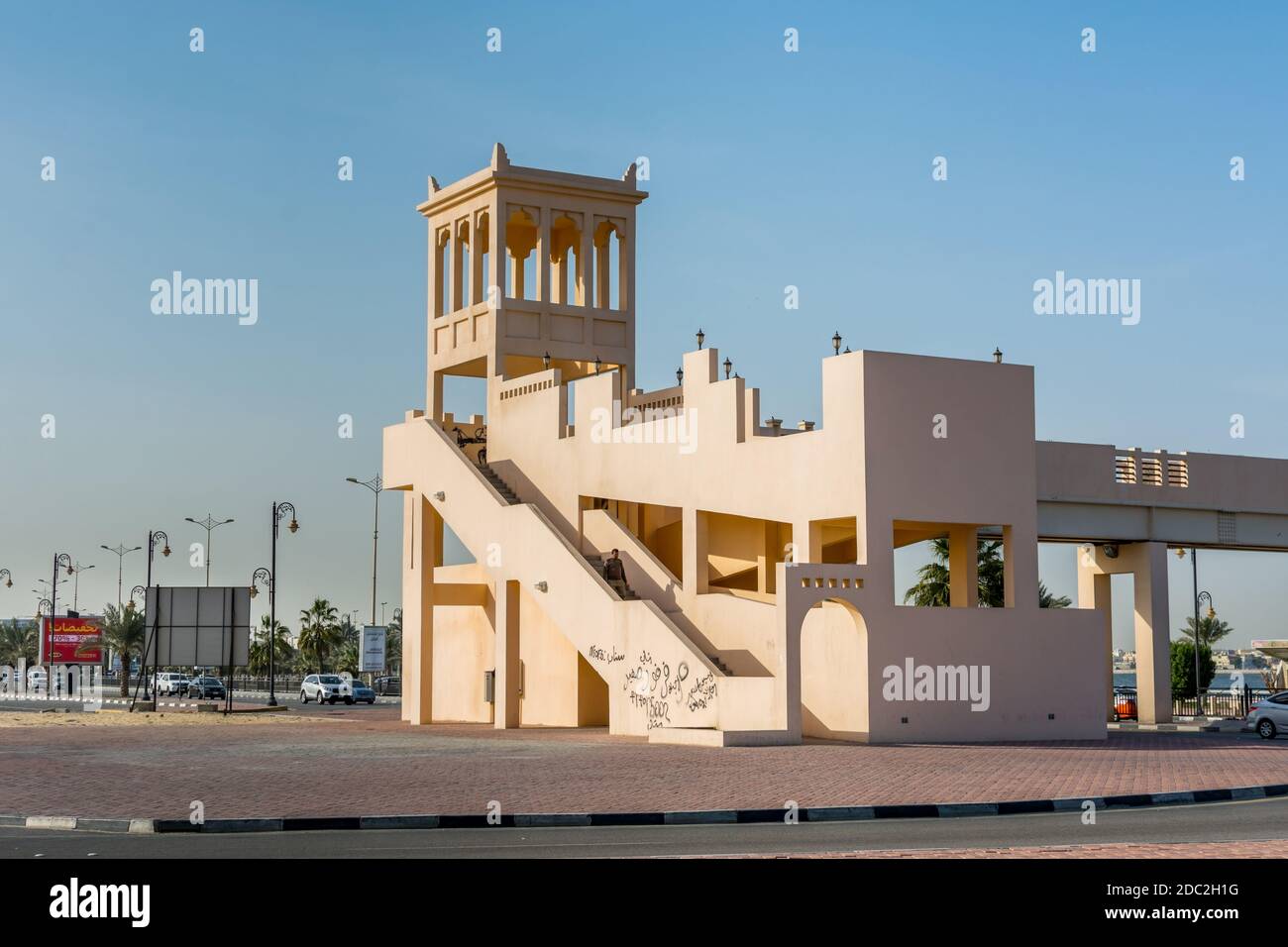 A footbridge with background of modern shopping mall near the corniche ...