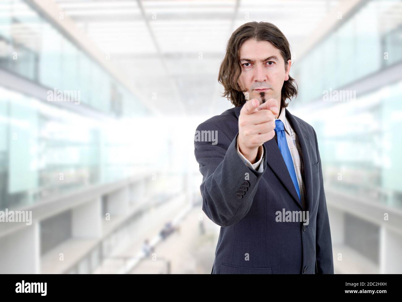 businessman in a suit pointing with his finger, at the office Stock ...
