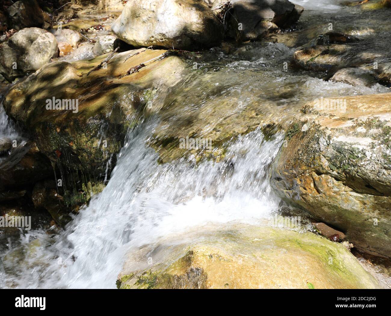 bubbling water of a mountain stream during the melting of glaciers ...