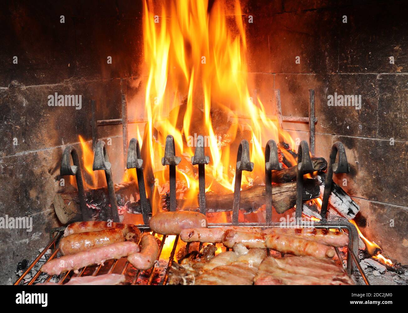 large flame in the fireplace while grilling meat Stock Photo - Alamy