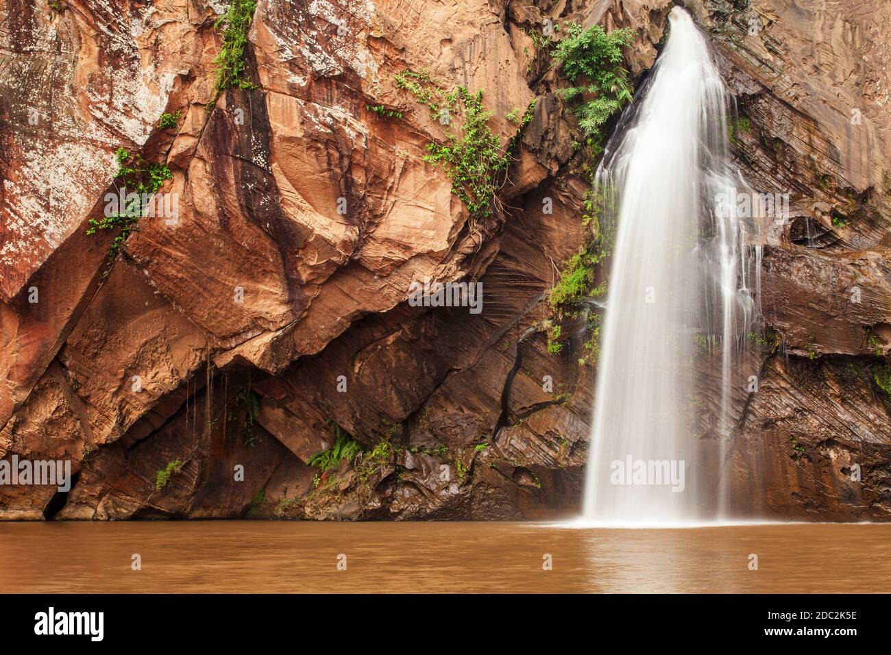 Gorgeous waterfall on grand sandstone wall in rain season, abstract ...
